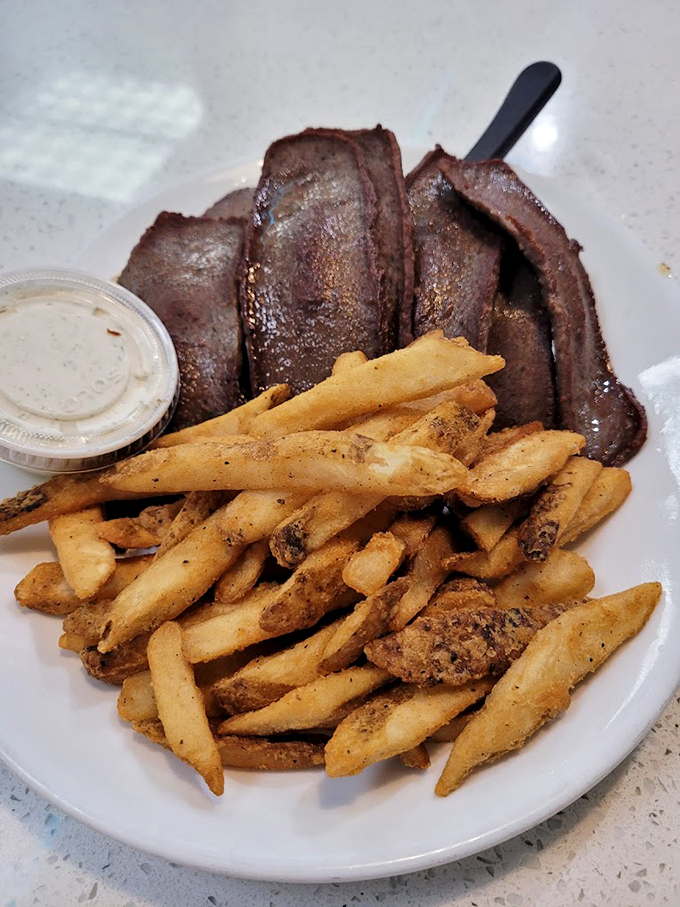 Holy cow! Or should I say, holy gyro? This plate is a carnivore's dream come true. Those fries look crispier than my grandma's wit!