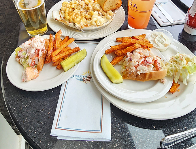 The holy trinity of Maine cuisine: lobster rolls, crispy fries, and... is that mac and cheese I spy? Comfort food, seaside style!