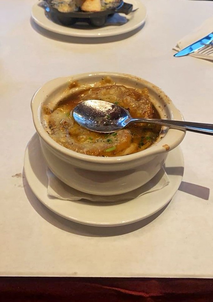 Behold, the French Onion Soup that launched a thousand sighs. A golden crust hiding a savory treasure beneath &ndash; it's comfort in a bowl.