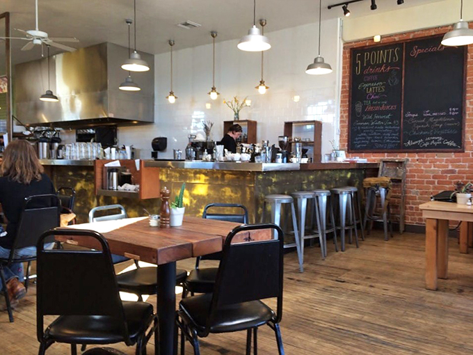 Industrial-chic meets cozy comfort with exposed brick walls and gleaming metal stools at this inviting counter space.