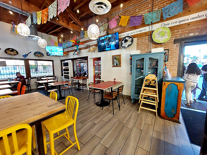 Where tradition meets modern charm: exposed brick walls, colorful banners, and pendant lights create a space that feels both authentic and fresh.