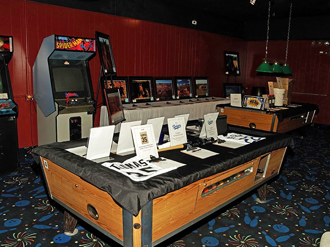 Classic arcade games stand ready in the corner, including Spider-Man himself, waiting to entertain between frames.