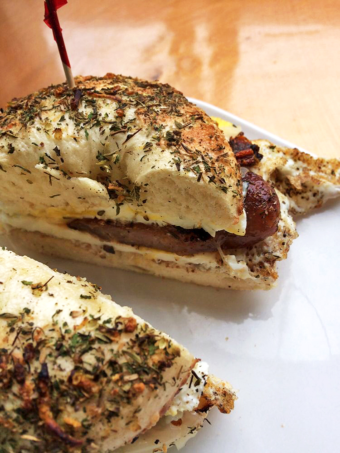 A bagel sandwich that looks like it graduated from culinary school but still remembers its hometown roots.