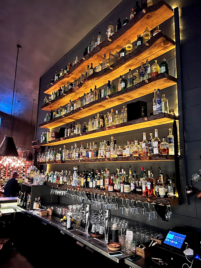 Not just a bar, but a library of spirits - illuminated wooden shelves showcase an impressive collection that would make any mixologist swoon. Photo credit: brian perkins