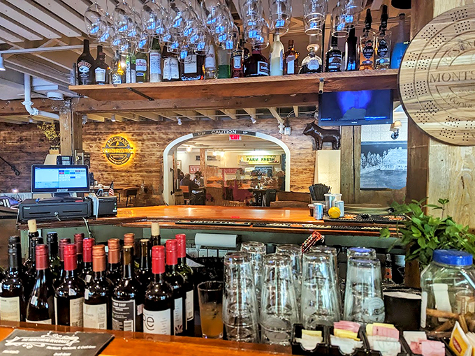 Behind this rustic wooden bar, local spirits and stories flow freely beneath vintage glassware and warm lighting.