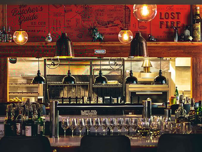 Behind this well-stocked bar, vintage-inspired lighting illuminates an impressive array of spirits, ready for crafting the perfect cocktail. Photo credit: The Aperitivo