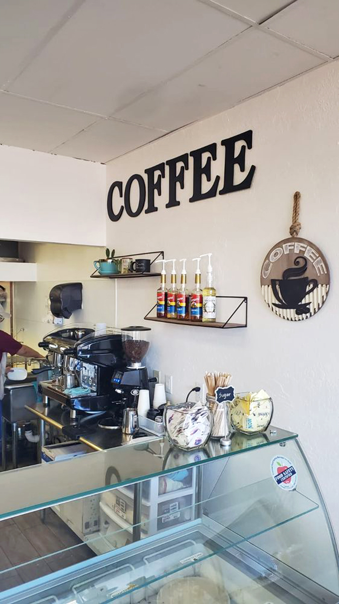 The coffee station stands ready, with syrups lined up like soldiers awaiting their call to flavor duty.