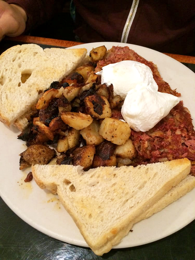 Crispy-edged potatoes and tender corned beef unite under perfectly poached eggs - this is what breakfast harmony looks like.
