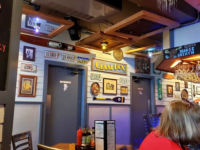 A whimsical collection of vintage license plates and nautical memorabilia transforms the walls into a museum of coastal Maine memories. Photo credit: Suzie Hilbert