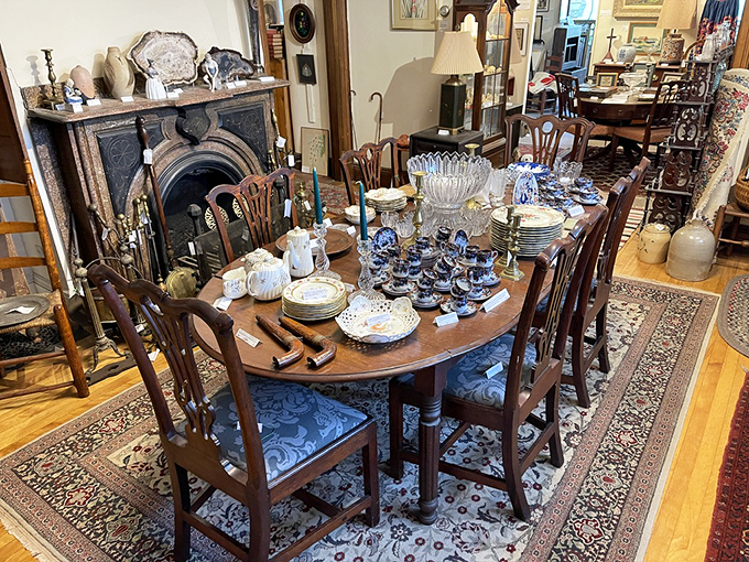 This elegant dining setup looks ready for a Downton Abbey dinner party, complete with period-perfect china and crystal.