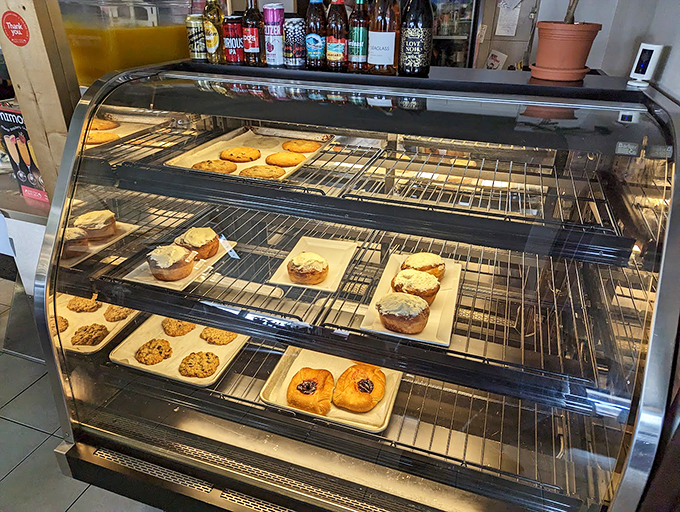 Behold, the glass case of temptation! From cookies to cinnamon rolls, this display is sweeter than a candy store run by Willy Wonka himself.