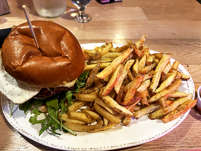 This isn't just any burger &ndash; it's a masterpiece on a bun, served with perfectly golden fries that look like they've been touched by King Midas himself. Photo credit: Phat Nguyen