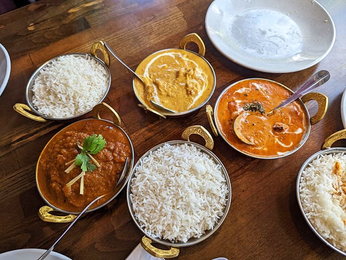 A feast fit for a maharaja! Golden curries and fluffy basmati rice create an aromatic tableau that's pure comfort in bowl form. Photo credit: Ching C.