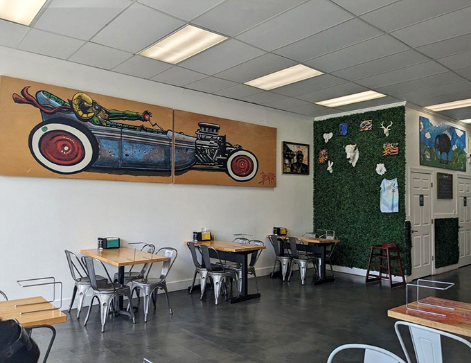 Industrial meets artsy in this airy dining room, where vintage hot rod artwork races across walls lined with modern metal seating.