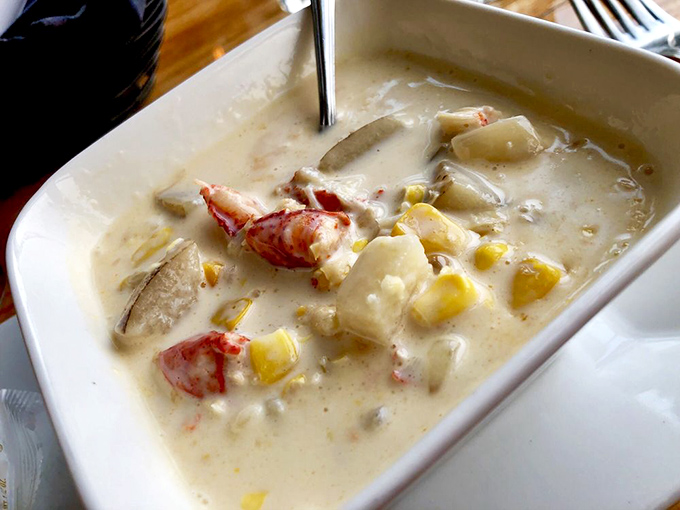 Chunks of fresh lobster swim in a creamy sea of corn chowder. This isn't just soup, it's a warm embrace in a bowl.