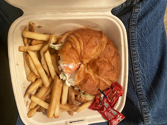 This isn't your ordinary takeout container &ndash; it's a treasure chest of fresh lobster nestled in a perfectly golden croissant. Photo credit: Bridget L.