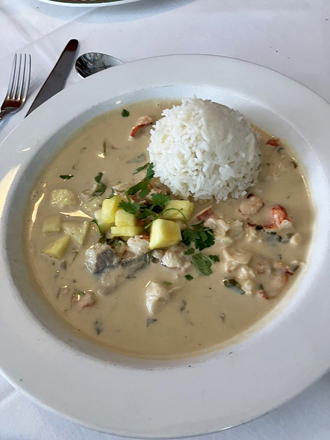 Creamy coconut broth cradles tender Maine lobster like it's giving it a warm tropical hug. A vacation in every spoonful! 