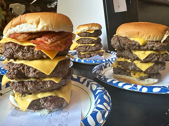 Behold, the leaning towers of beef! These burgers aren't just meals; they're edible skyscrapers that would make Frank Lloyd Wright jealous.