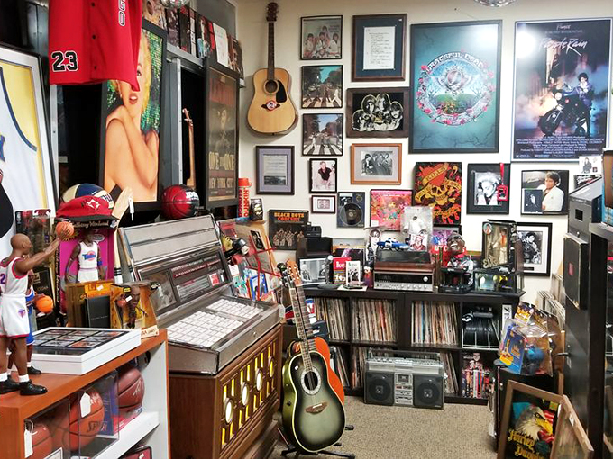 A wall of musical history where Beatles albums meet Purple Rain posters.Even the guitar seems to hum with vintage vibes.