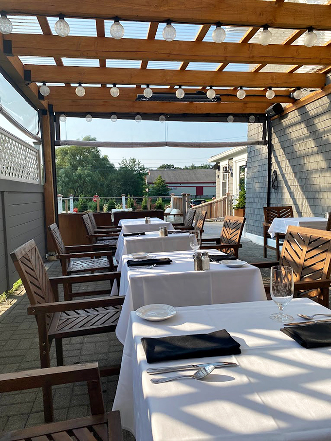 String lights twinkle above the outdoor dining area, where summer evenings transform into magical al fresco experiences. Photo credit: jacqueline l