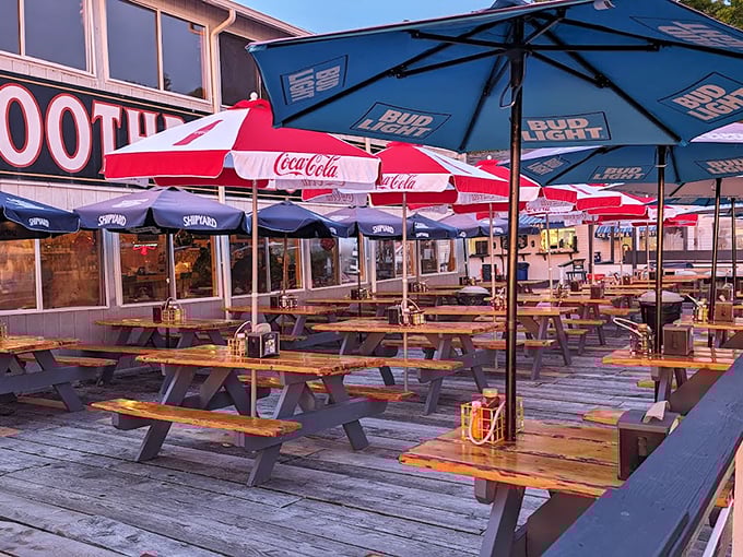 Shipyard and Coca-Cola umbrellas dot the waterfront deck, where every table offers a front-row seat to harbor life. Photo credit: A Z