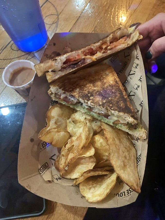 This isn't your mother's grilled cheese &ndash; melted perfection meets garden-fresh pesto in a sandwich that's pure comfort. Photo credit: Michelle I.
