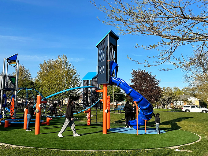 Modern playground equipment transforms this corner of the park into a colorful obstacle course that would make American Ninja Warriors jealous.
