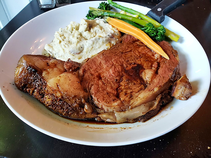This prime rib isn't just dinner &ndash; it's a masterpiece of marbling, served with creamy mashed potatoes and perfectly crisp vegetables.