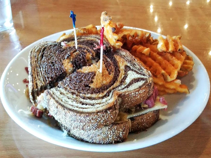 This Reuben comes with a side of golden tater tots and a view that makes lunch feel like a vacation.