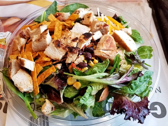 Fresh greens, grilled chicken, and crispy tortilla strips come together in a salad that's definitely not your typical drive-thru fare. Photo credit: Andrew Mass