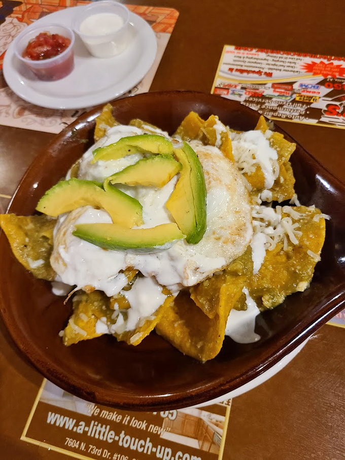 These nachos aren't messing around - loaded with creamy sauce, fresh avocado, and enough toppings to make every bite count. Photo credit: Amber Irvin