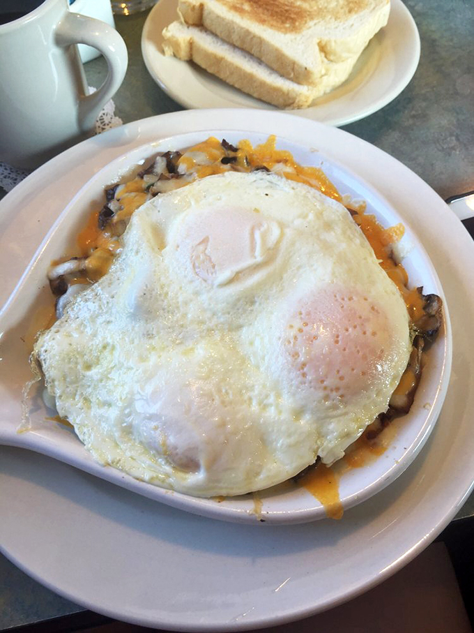 A sunny-side-up egg floats like a golden cloud over a hearty skillet that's ready to jump-start your day.