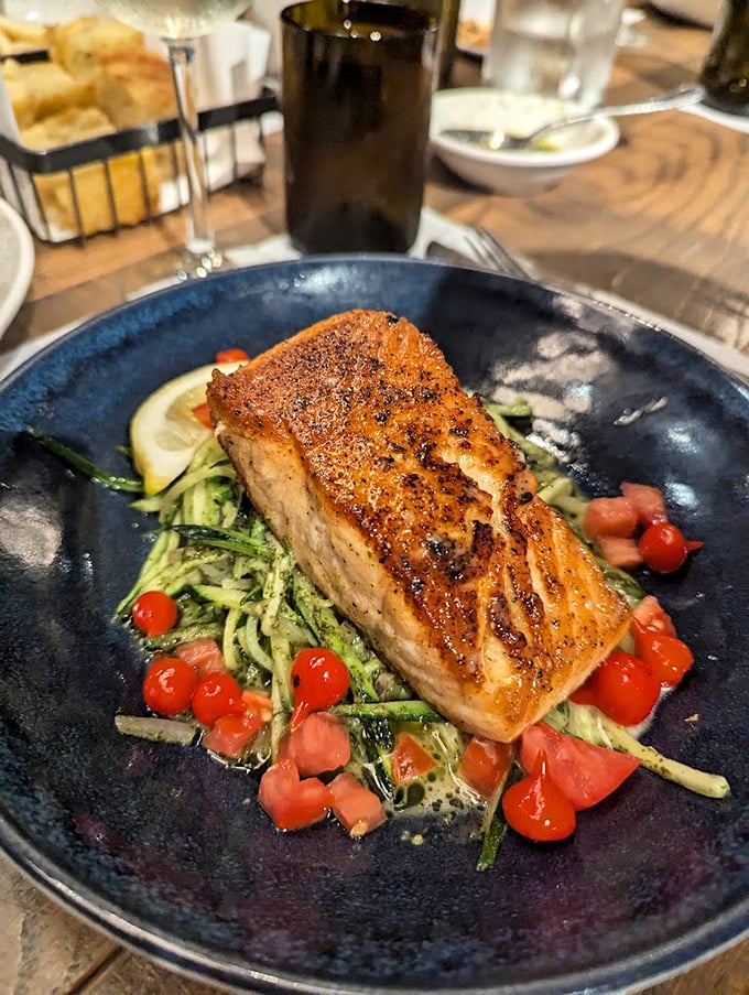 This blackened beauty lounges on a bed of zucchini noodles, surrounded by cherry tomatoes like tiny red exclamation points of flavor.