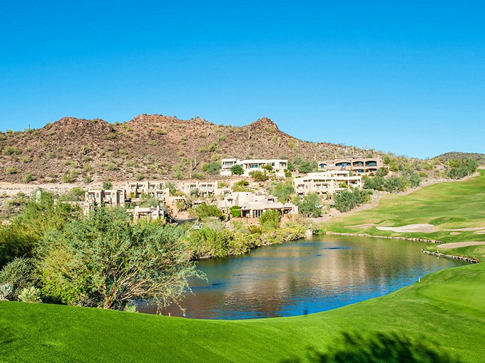 Desert-inspired architecture cascades down the hillside, blending seamlessly with the natural landscape and pristine golf greens.