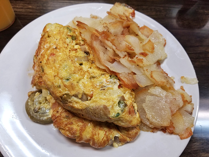 Veggie lovers, rejoice! This omelet is so packed with fresh ingredients, it's like a farmer's market wrapped in a fluffy egg blanket.