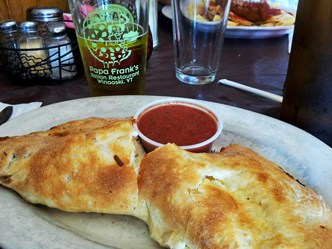 Behold, the calzone in its natural habitat! This golden-brown pocket of joy is what carb dreams are made of.