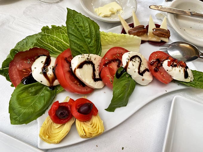 Mozzarella and tomatoes: a love story for the ages. This caprese is so fresh, you'll swear you heard the basil whisper "ciao" as it was plucked.