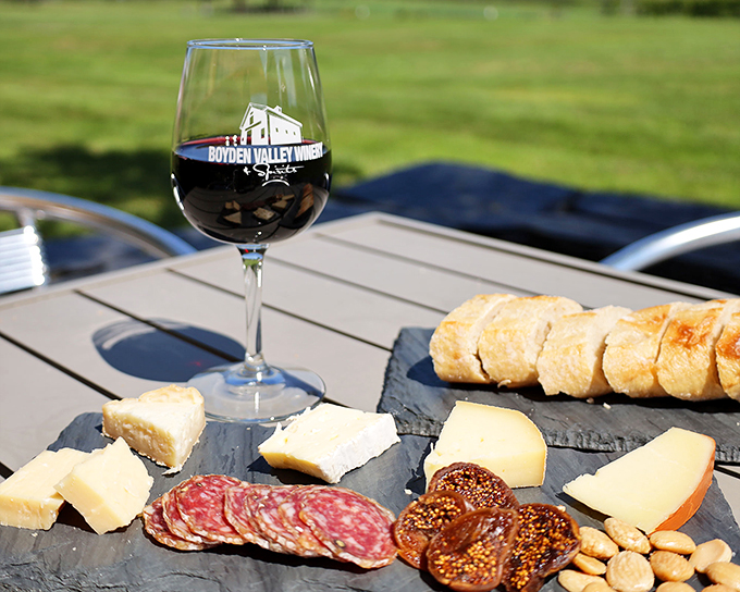 Who needs a red carpet when you've got this spread? A star-studded cast of local cheeses, meats, and bread takes center stage, with wine playing the perfect supporting role.