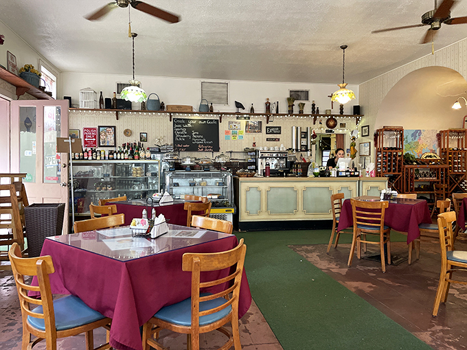 Step into a time warp! This cozy dining area feels like your European grandmother's kitchen, if she had a penchant for mismatched chairs and quirky decor. Photo credit: Ilya Os