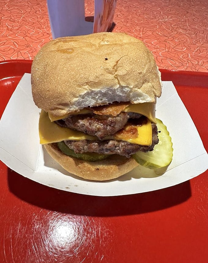 Holy cow! This double cheeseburger isn't just a meal, it's a skyscraper of savory satisfaction that would make even the Flintstones say "Yabba dabba delicious!"