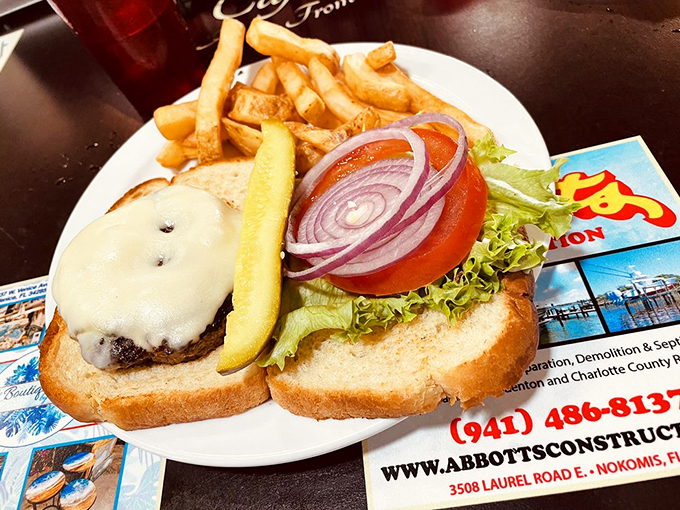 Burger bliss on a bun! This juicy masterpiece is stacked higher than your grandkid's Lego tower, and twice as likely to make you smile. Photo credit: Consumer E.