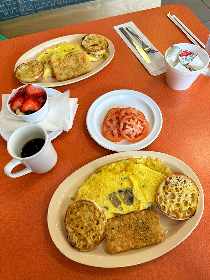 This breakfast spread is like a warm hug for your stomach. Fluffy omelet, crispy hash browns, and... is that bacon I spy?
