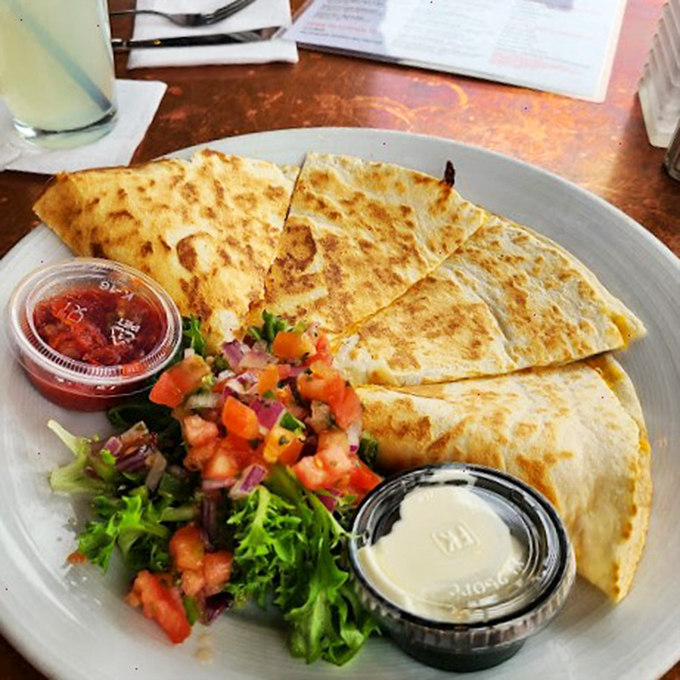 A quesadilla that means business, served with fresh pico de gallo and enough greens to make you feel virtuous about your cheese consumption.