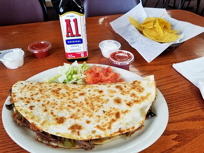 Taco 'bout a flavor explosion! This quesadilla is so stuffed, it's practically the Dolly Parton of Mexican-inspired Midwest cuisine.