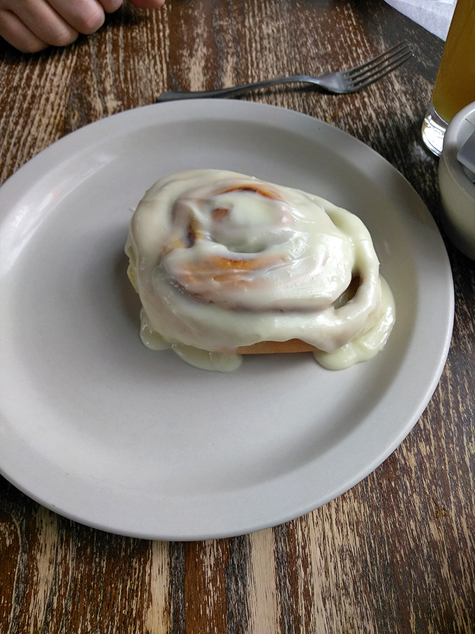 Holy pastry, Batman! This cinnamon roll isn't just big; it's the superhero of sweet treats, ready to save your morning one gooey bite at a time.