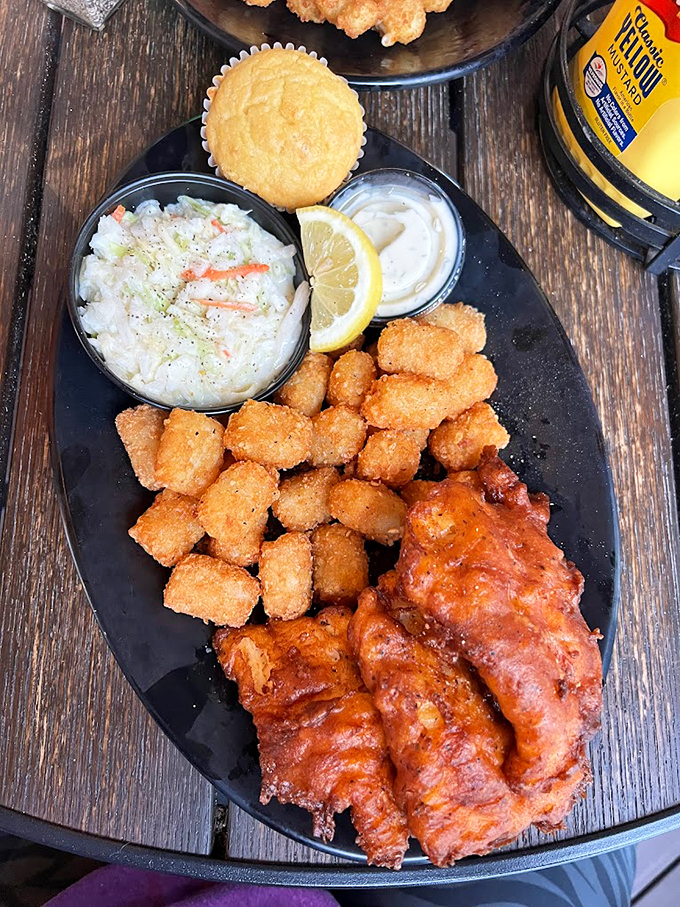 A platter that screams "vacation mode: activated!" Crispy fish, tangy slaw, and comfort food sides - it's like a hug for your taste buds.