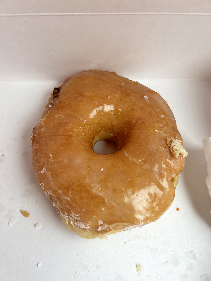 The holy grail of road trip snacks - a perfectly glazed donut that's worth every sticky finger.