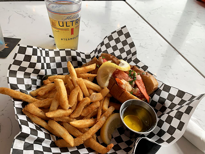 The dynamic duo of comfort food: a lobster roll that could make a mermaid jealous, paired with fries so golden they'd make King Midas blush.