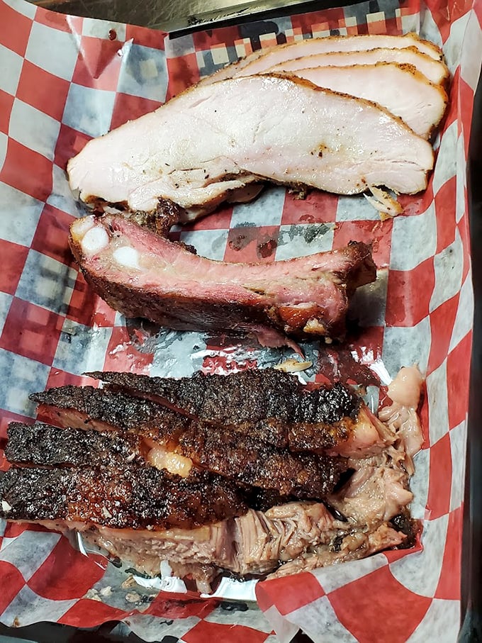 The holy trinity of BBQ: brisket, ribs, and pure joy. This plate is what meat lovers' dreams are made of.