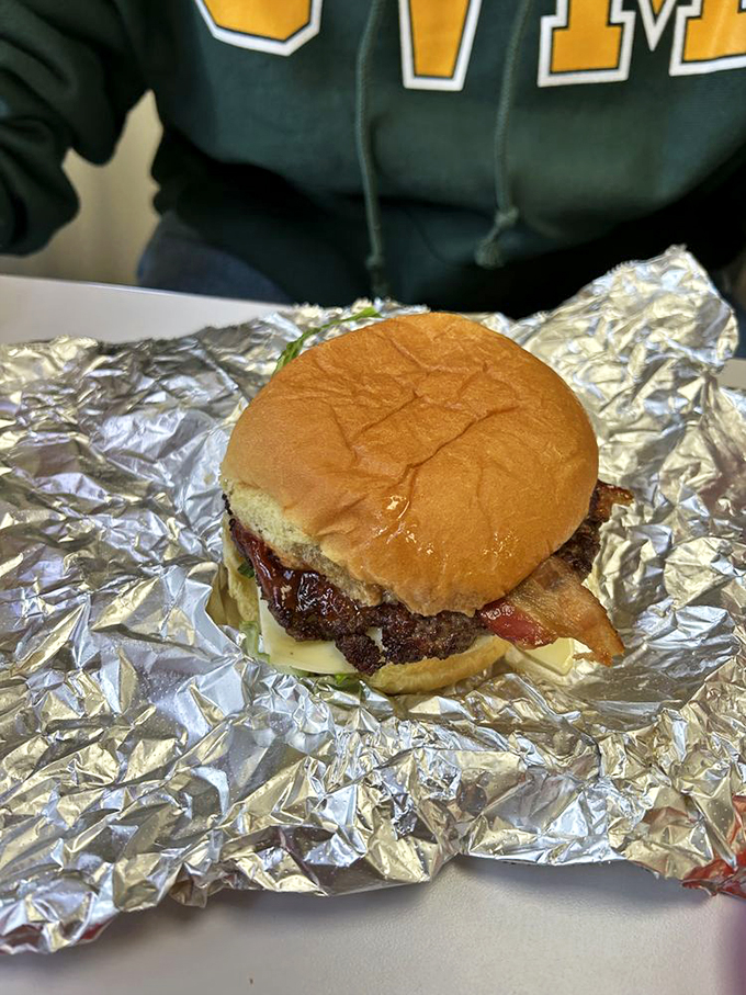 Burger bliss on a bun! This all-American classic is dressed to impress, nestled in its silver throne like food royalty.